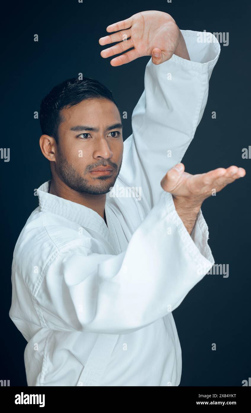 Training, karate and man in martial arts on studio, black background ...
