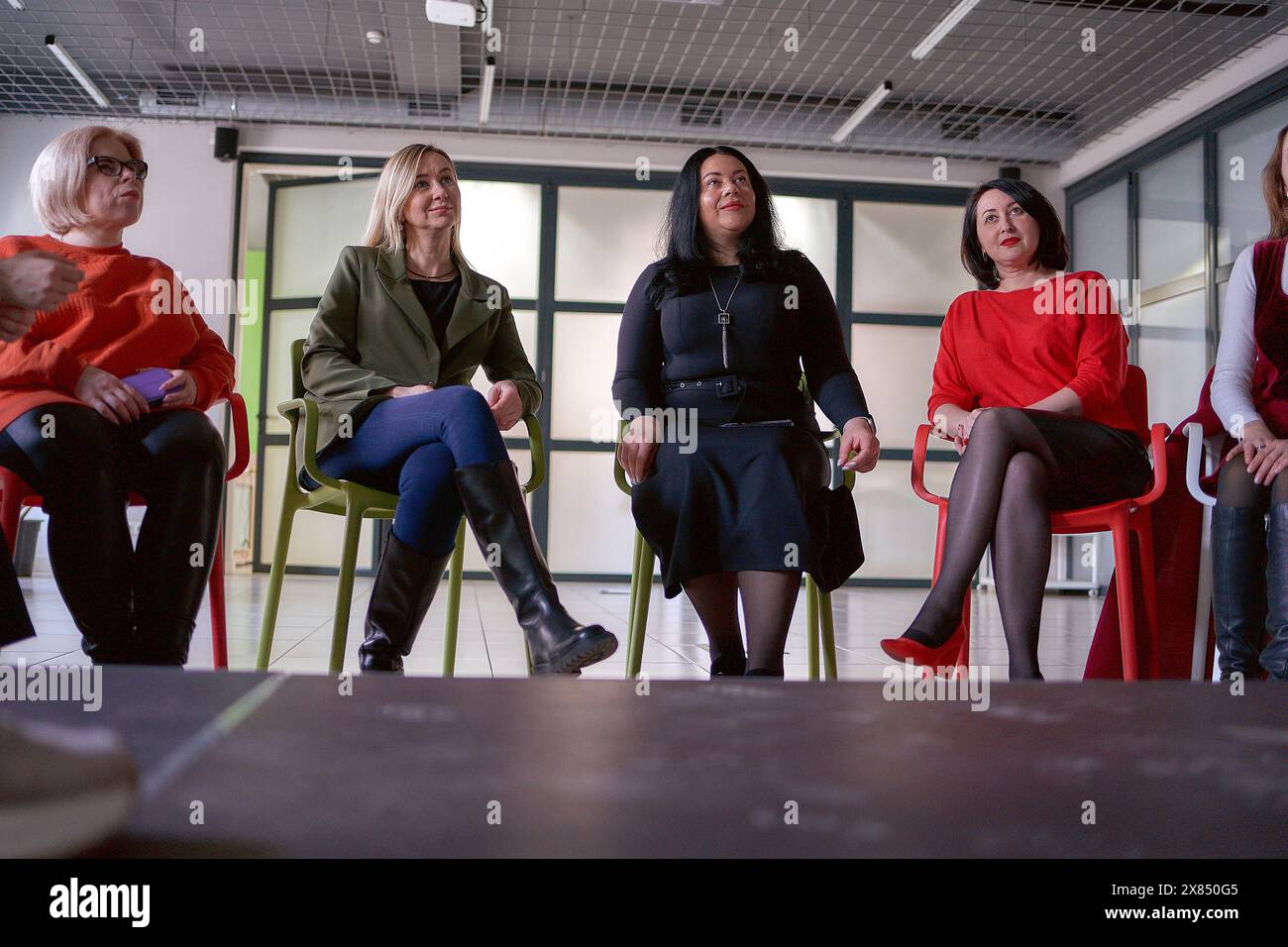 office workers listen to their colleagues on stage, view from the stage ...