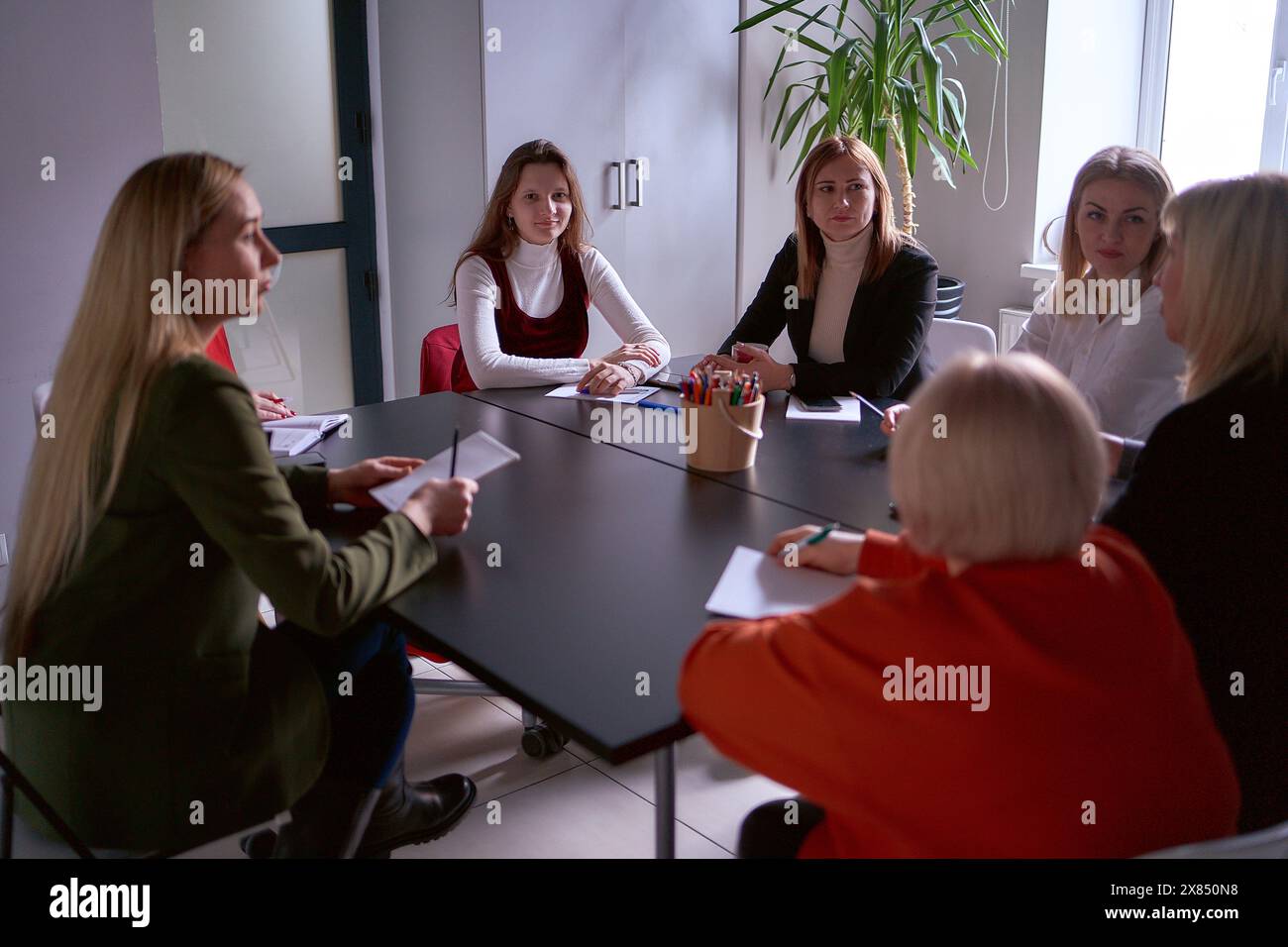 Team seven women holding hi-res stock photography and images - Alamy