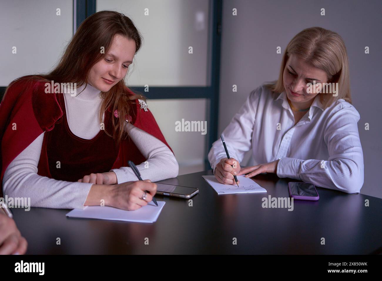 small team of three women work in the office Stock Photo - Alamy