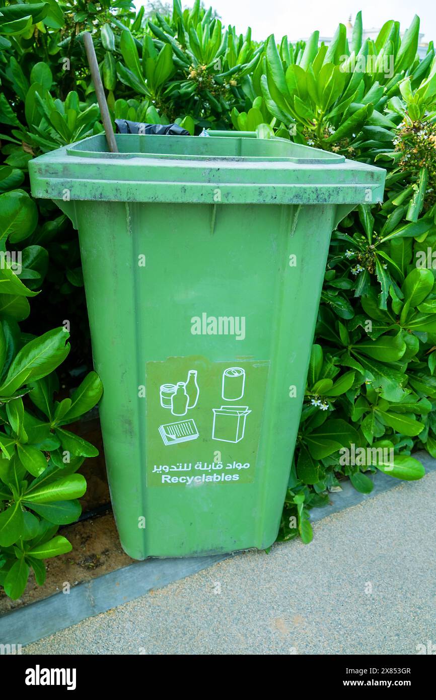Garbage container on the street. Recycling. The area is fenced with a ...