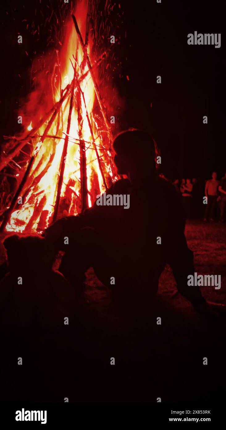 Huge fire at night and young people around. Pagan festival of Walpurgis ...