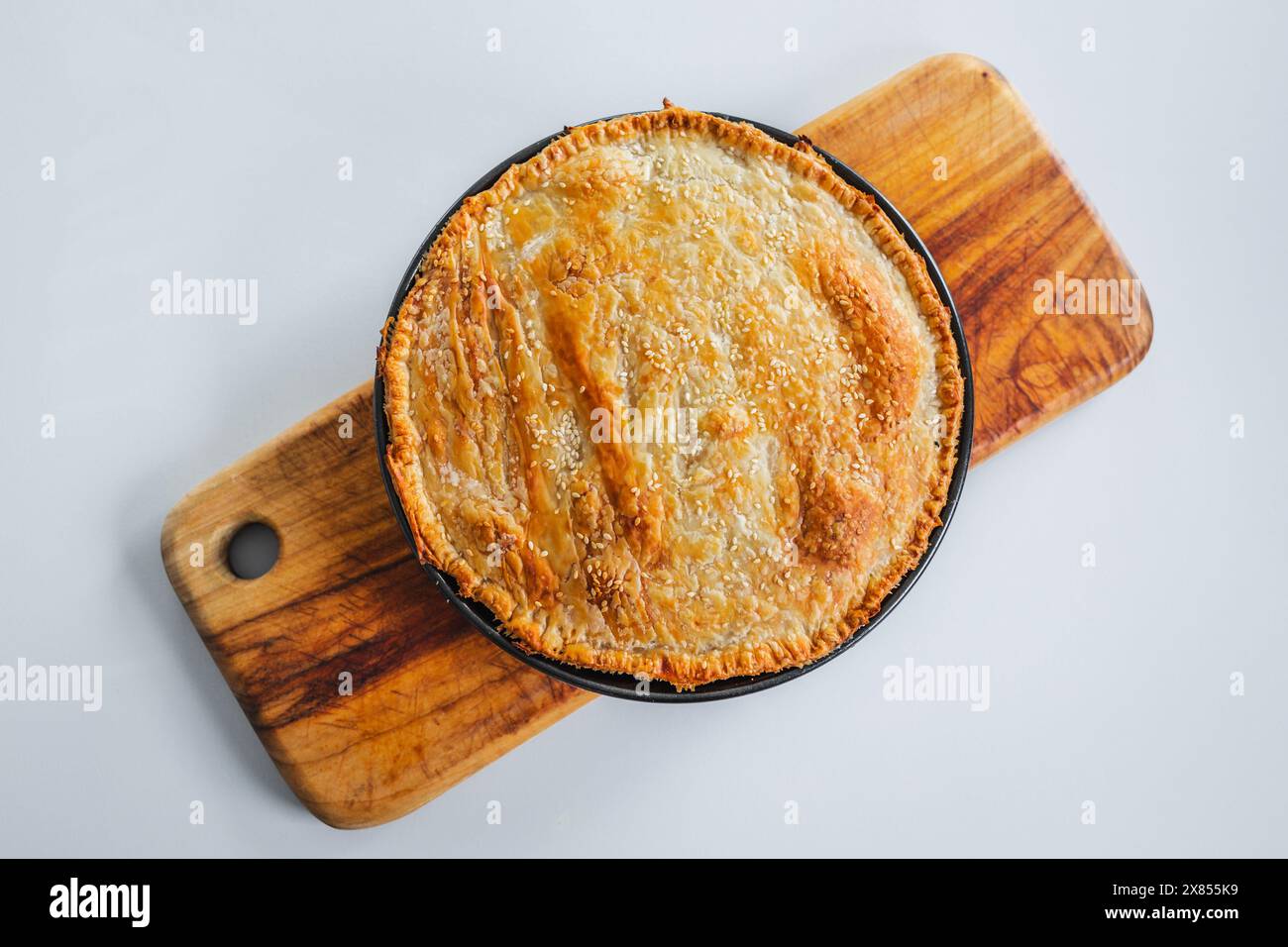 homemade round puff pastry pie in style of a sheperd's pie with sesame ...