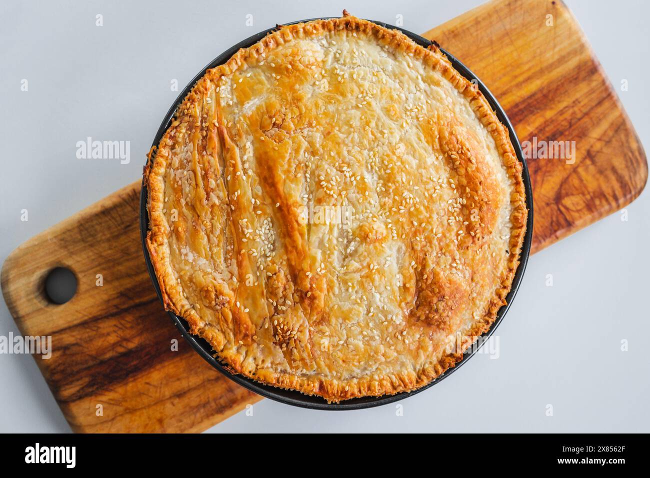 homemade round puff pastry pie in style of a sheperd's pie with sesame ...