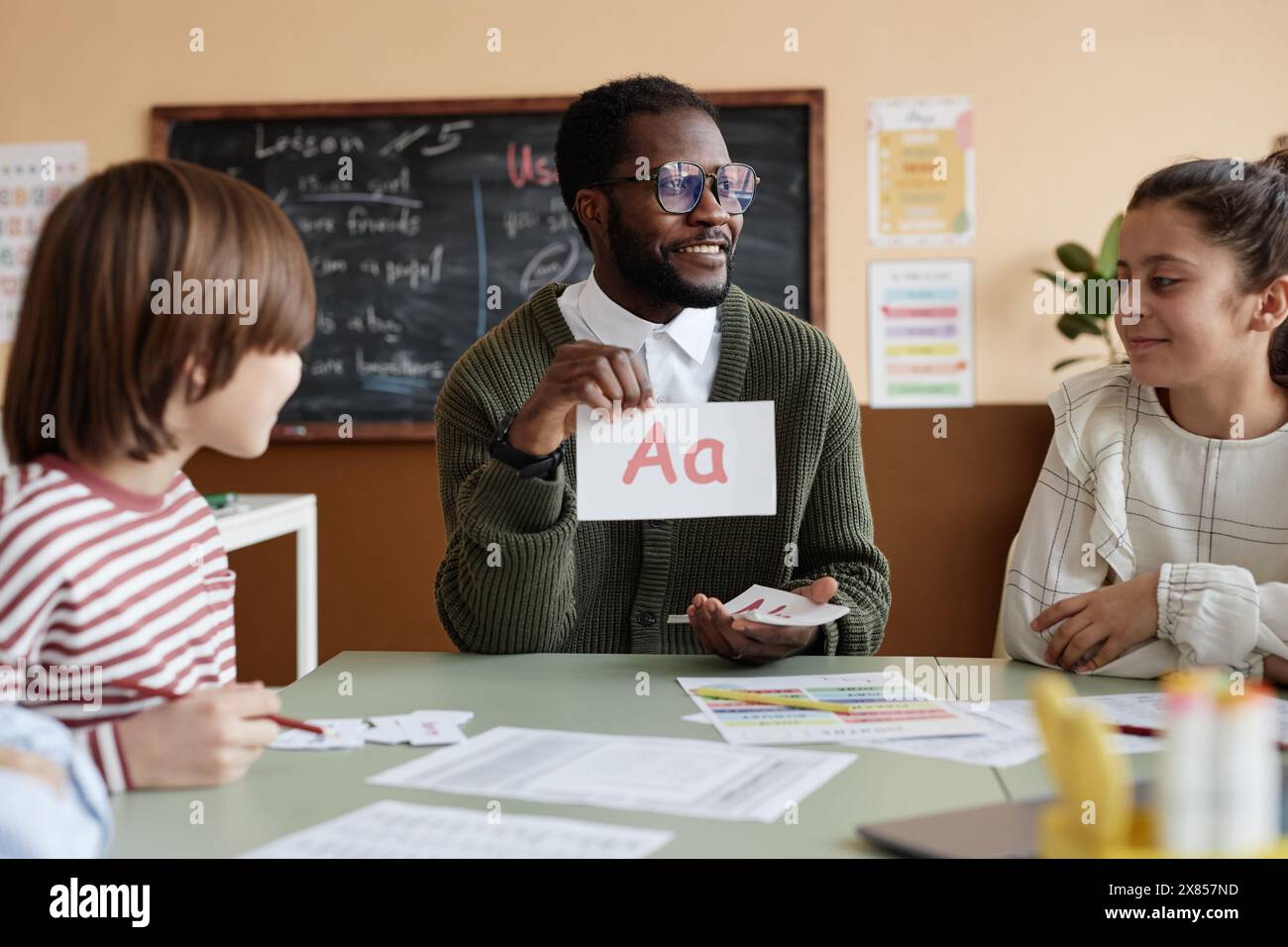 Medium shot of cheerful African American teacher of foreign language ...