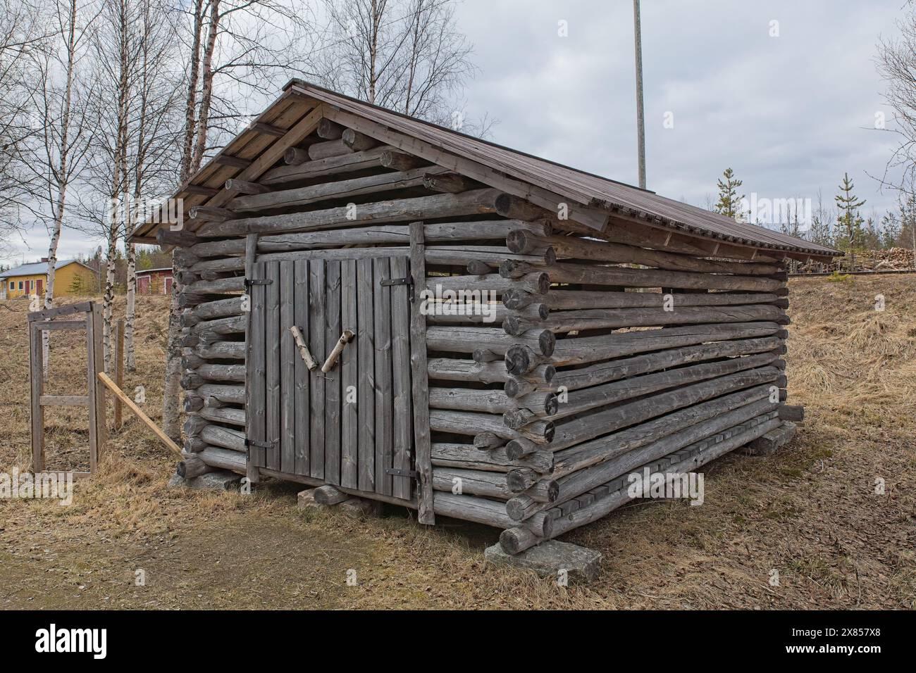 Old log barn in cloudy spring weather at Riutukka Log Floating Museum ...