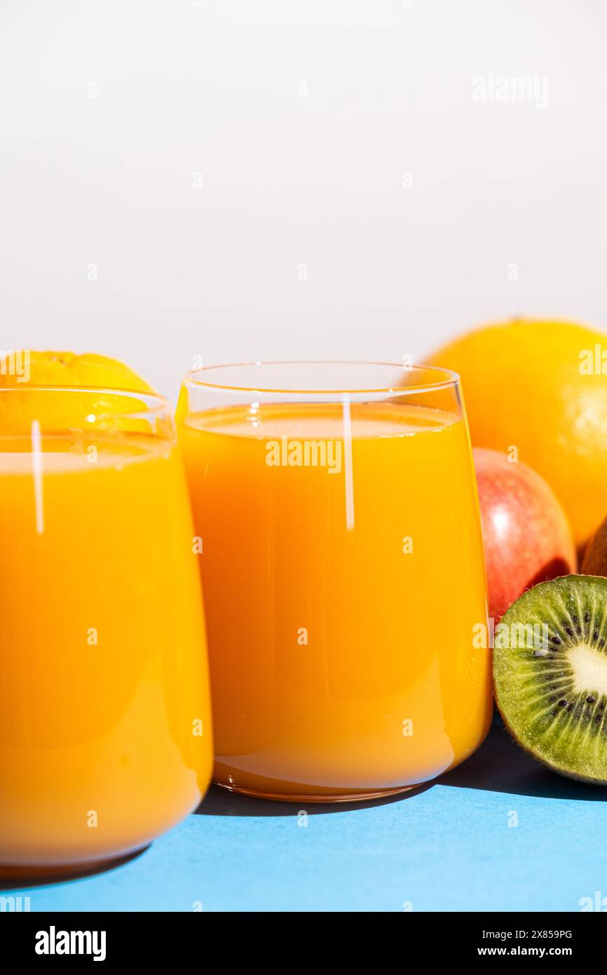 Multi-fruit juices in glasses among fresh fruits Stock Photo - Alamy