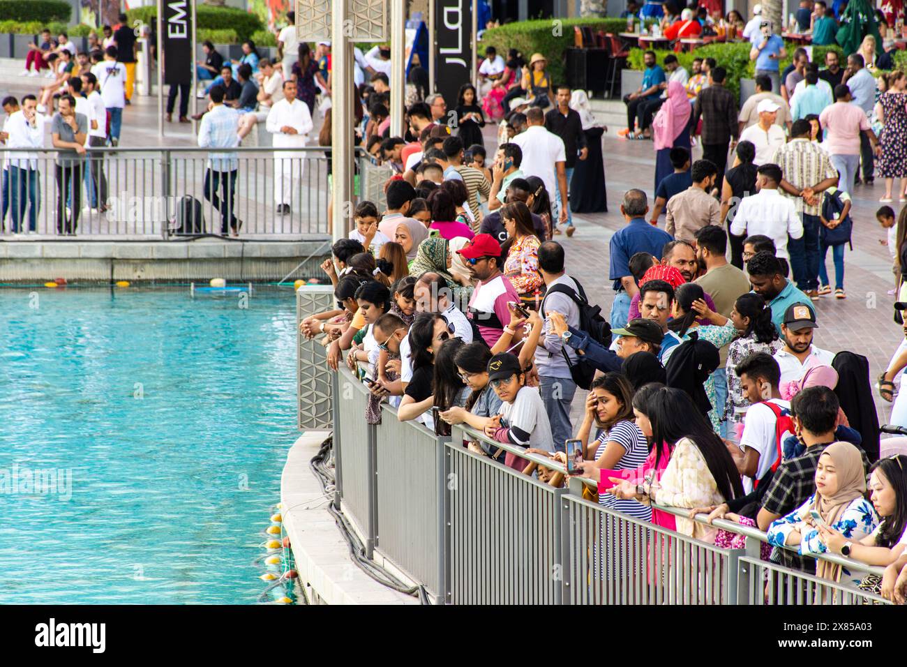 A crowd of tourists waiting for the Dubai Fountain show in Dubai Mall ...