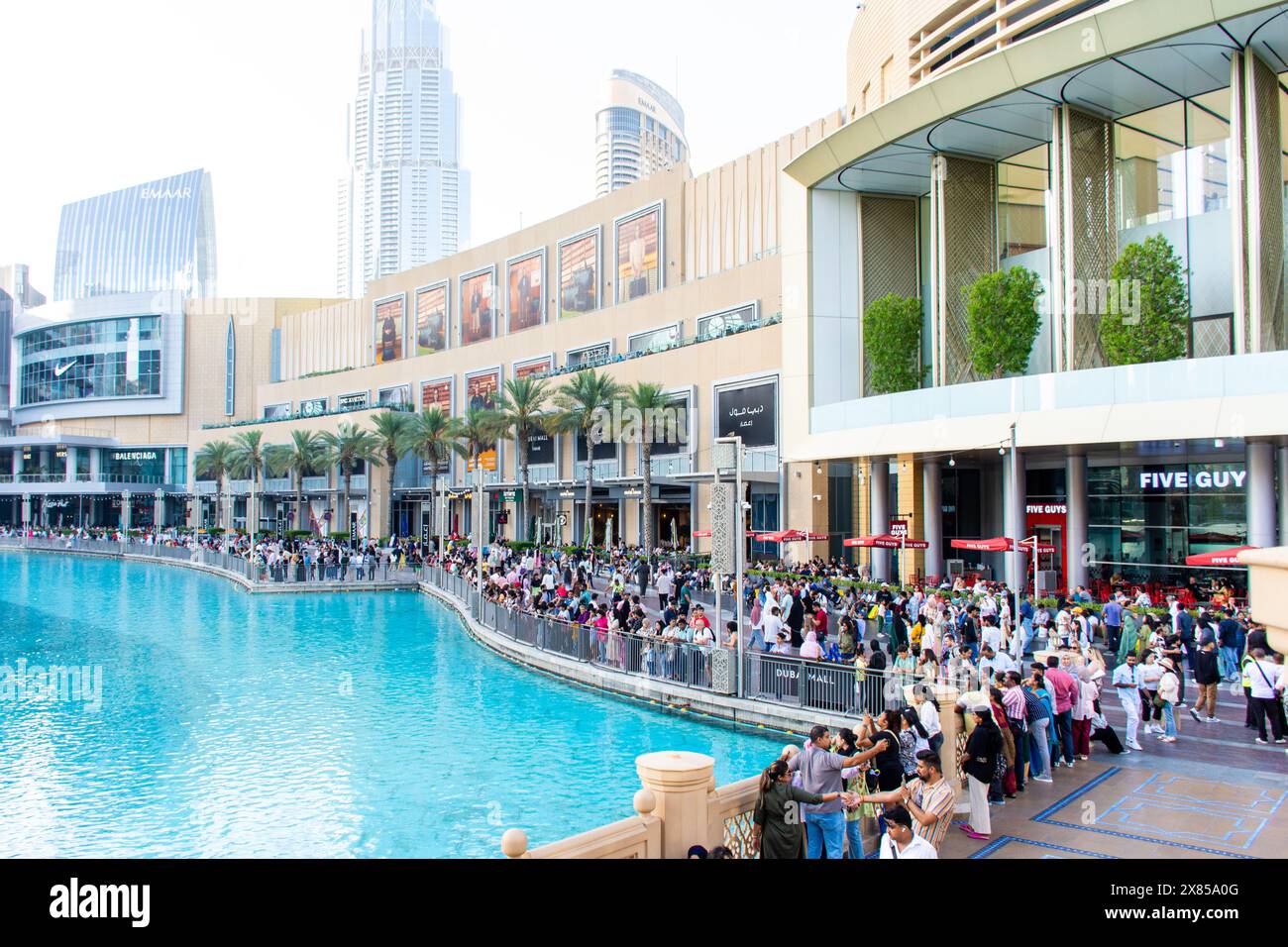 A crowd of tourists waiting for the Dubai Fountain show in Dubai Mall ...