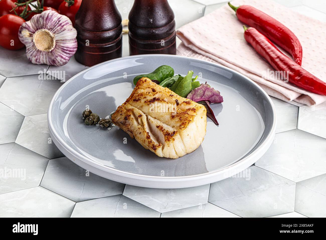 Roasted cod fish steak with salad leaves Stock Photo - Alamy