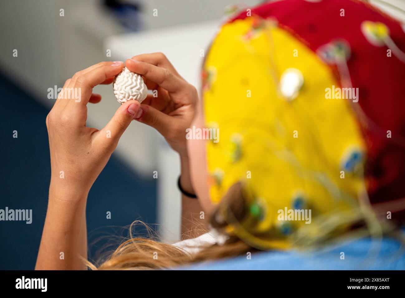 29 April 2024, Thuringia, Jena: An EEG subject wears an EEG cap with ...