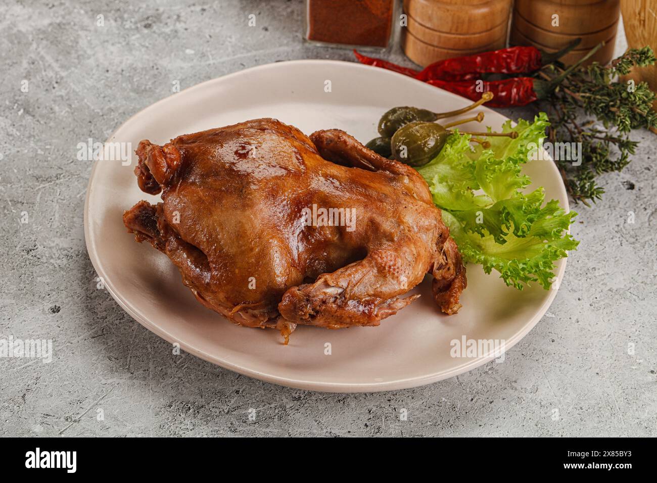 Baked whole small chicken with spices Stock Photo - Alamy