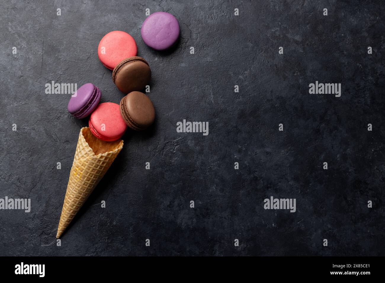 Various colorful macaroons. Flat lay sweets over stone background with ...