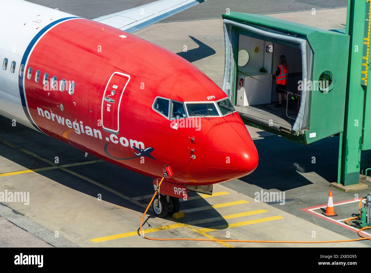 A boeing 737-800 from Norwegian airlines, in typical red and white ...