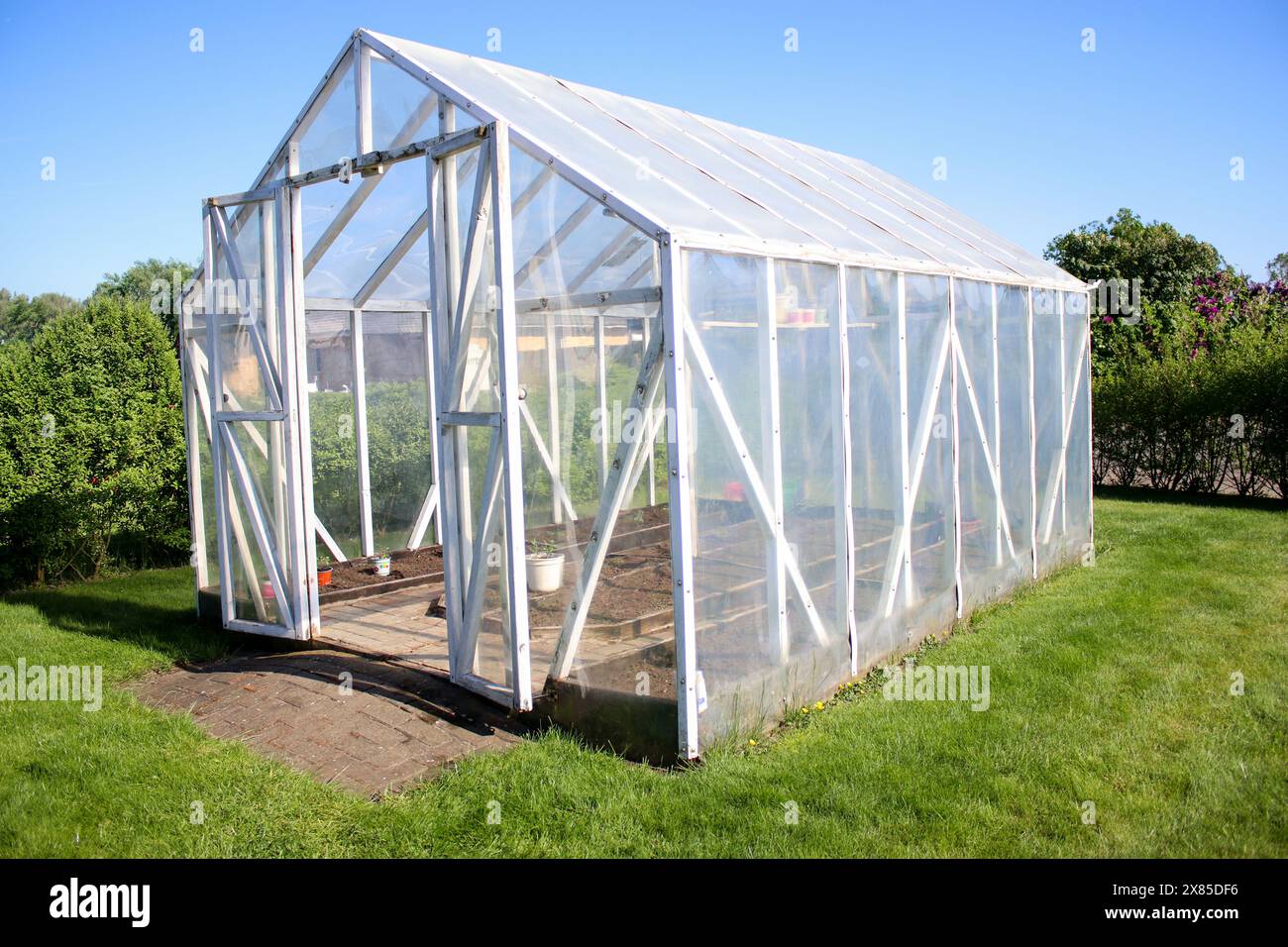 Big greenhouse garden in backyard Stock Photo - Alamy