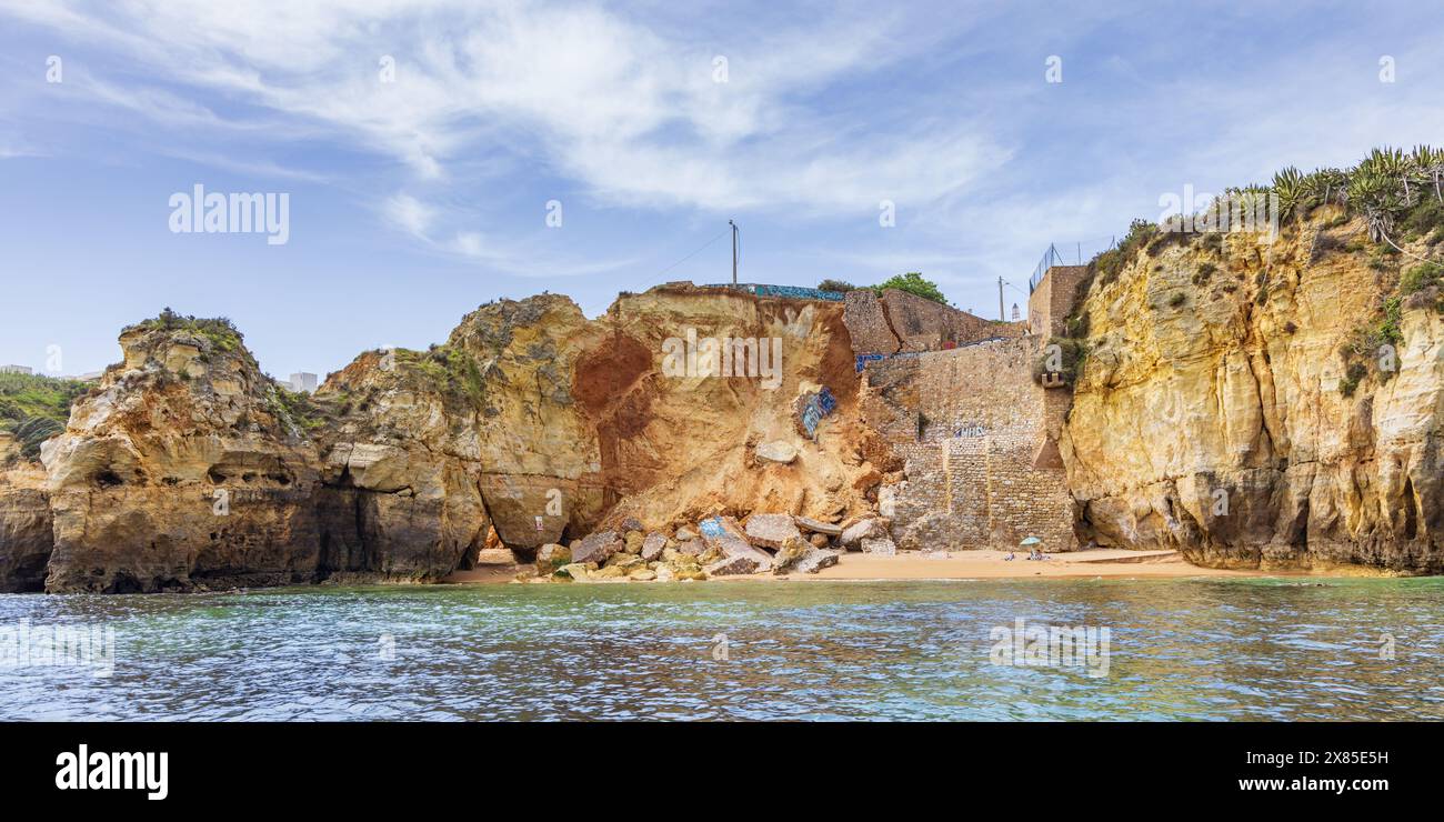 View from the sea of cliff coastal erosion at Praia do Pinhao beach ...