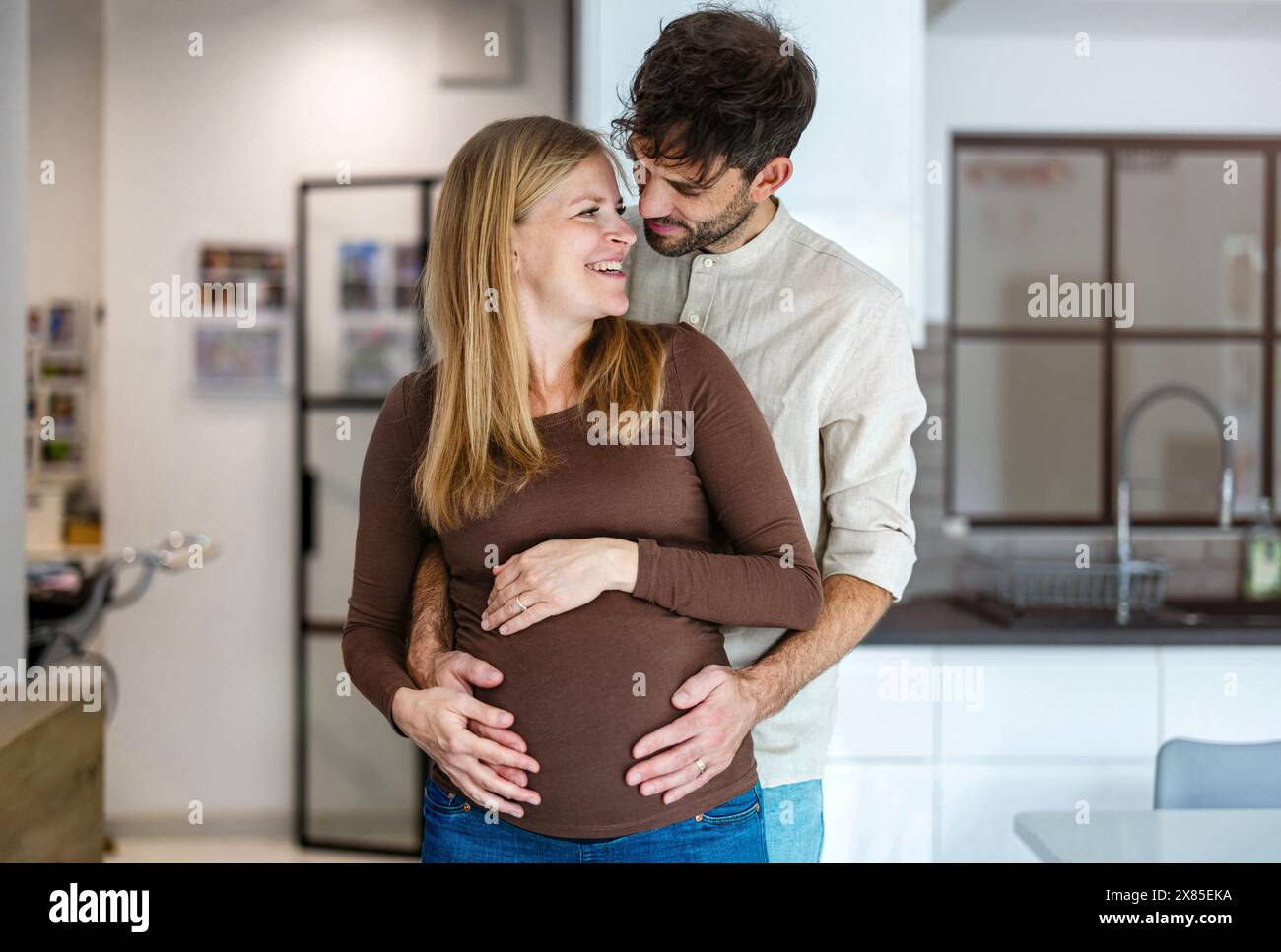 Portrait of a loving couple expecting a baby Stock Photo - Alamy