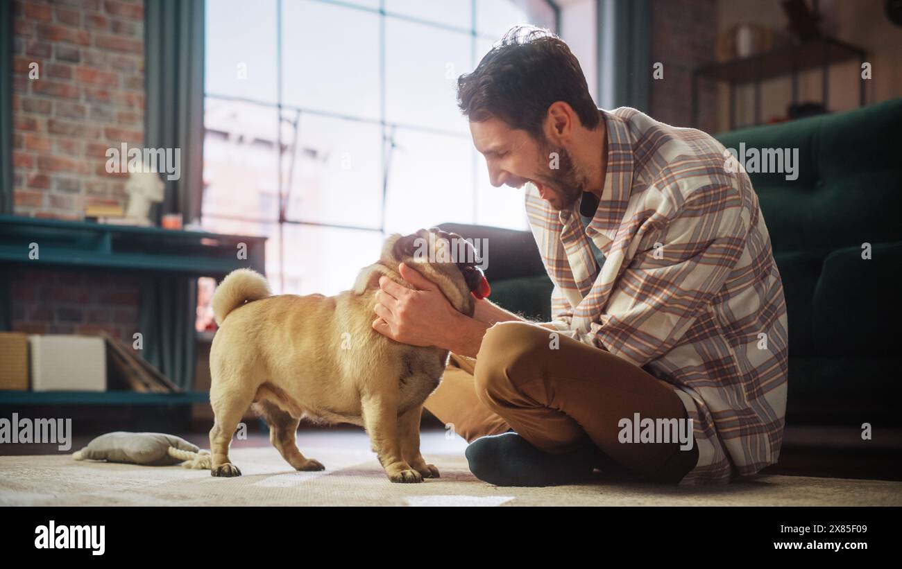 Happy Man Cuddles His Adorable Little Pug, Gives it Snacks at Home ...