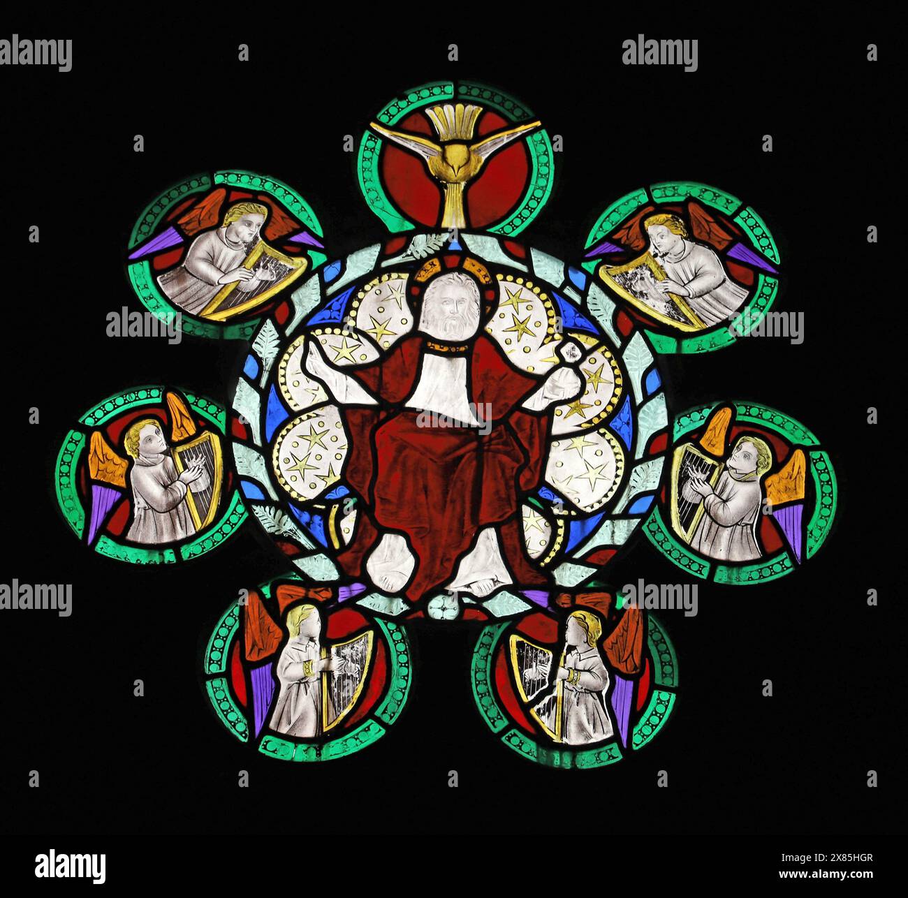 A stained glass window depicting Christ in Majesty surrounded by angels ...
