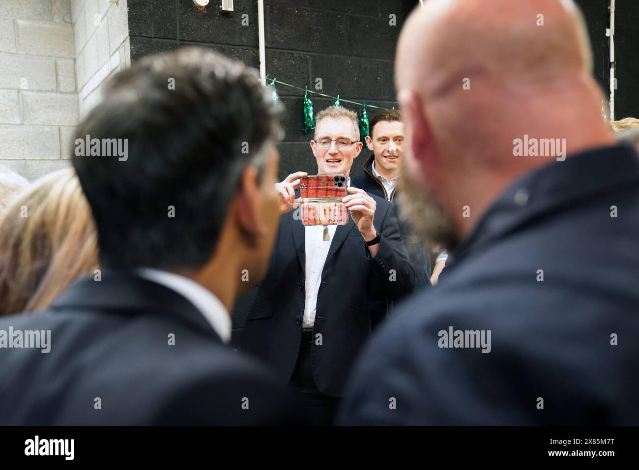 Welsh Secretary David TC Davies (centre) taking a photo of Prime ...
