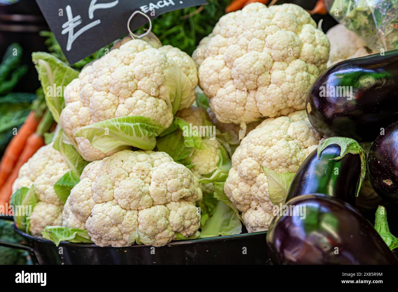 A display of vegetables on a farmers market stall, with a shallow depth ...