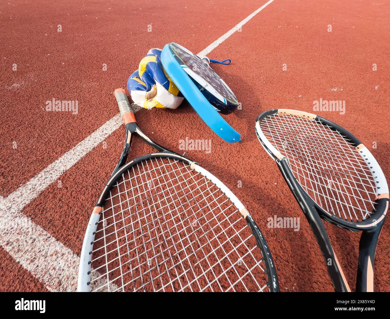 The broken rackets for playing tennis are hanging on the wall of a ...