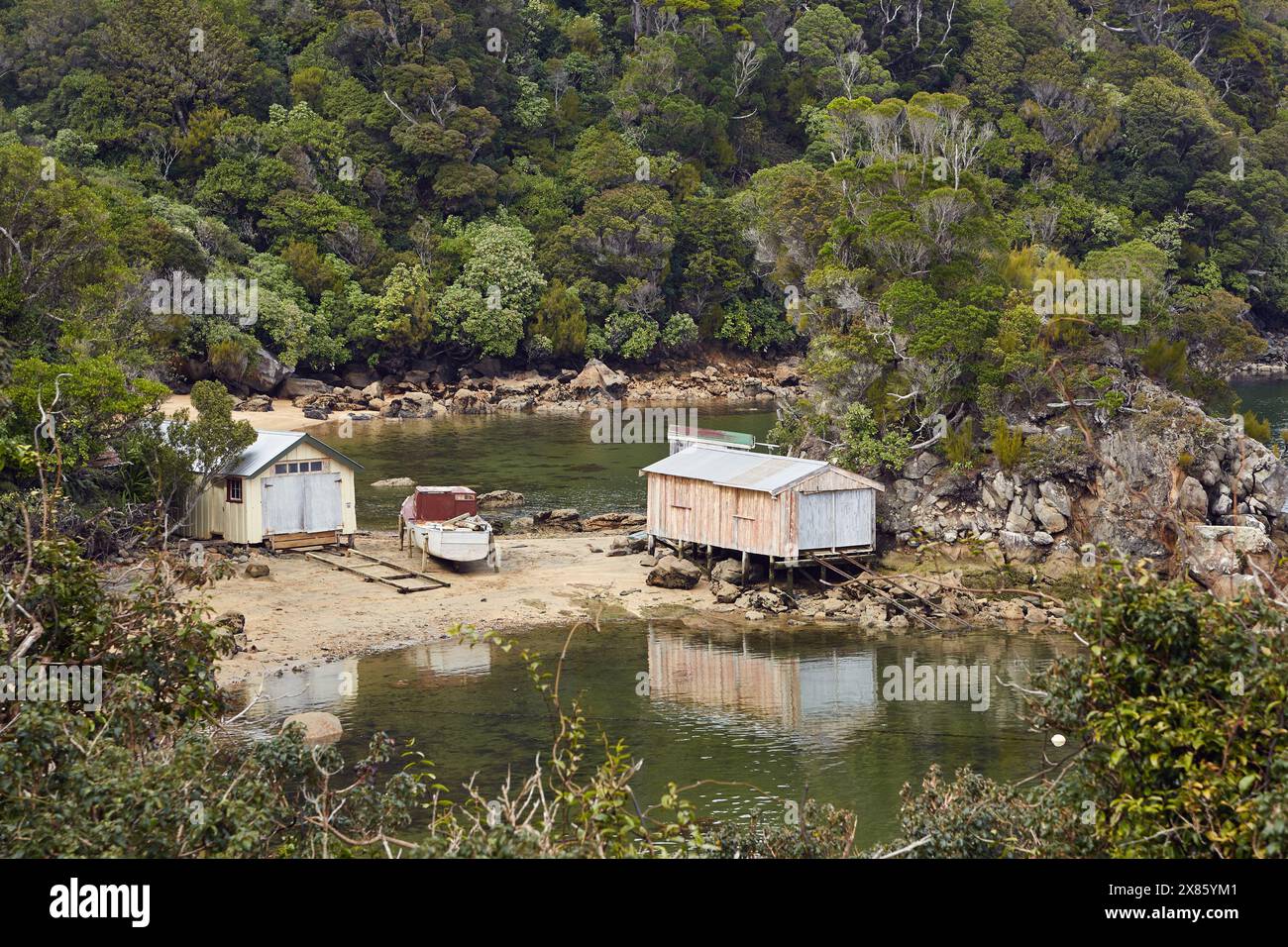 Small harbor with boat sheds in New Zealand Stewart Island Stock Photo ...