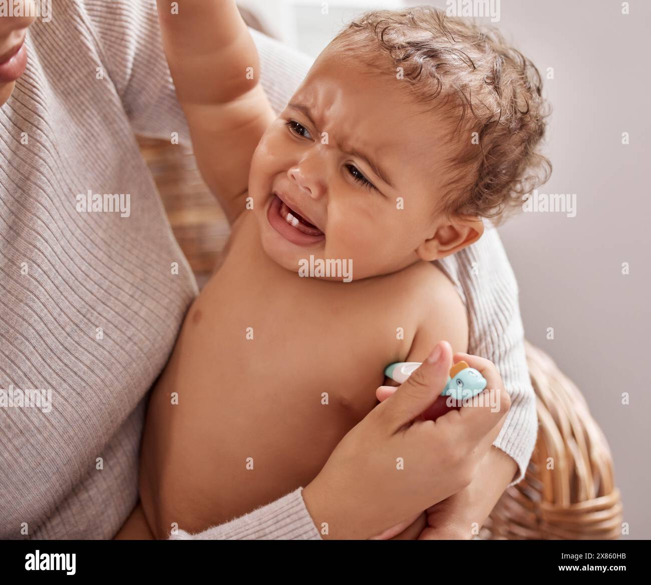 Baby, crying and mother with thermometer on skin for wellness check ...