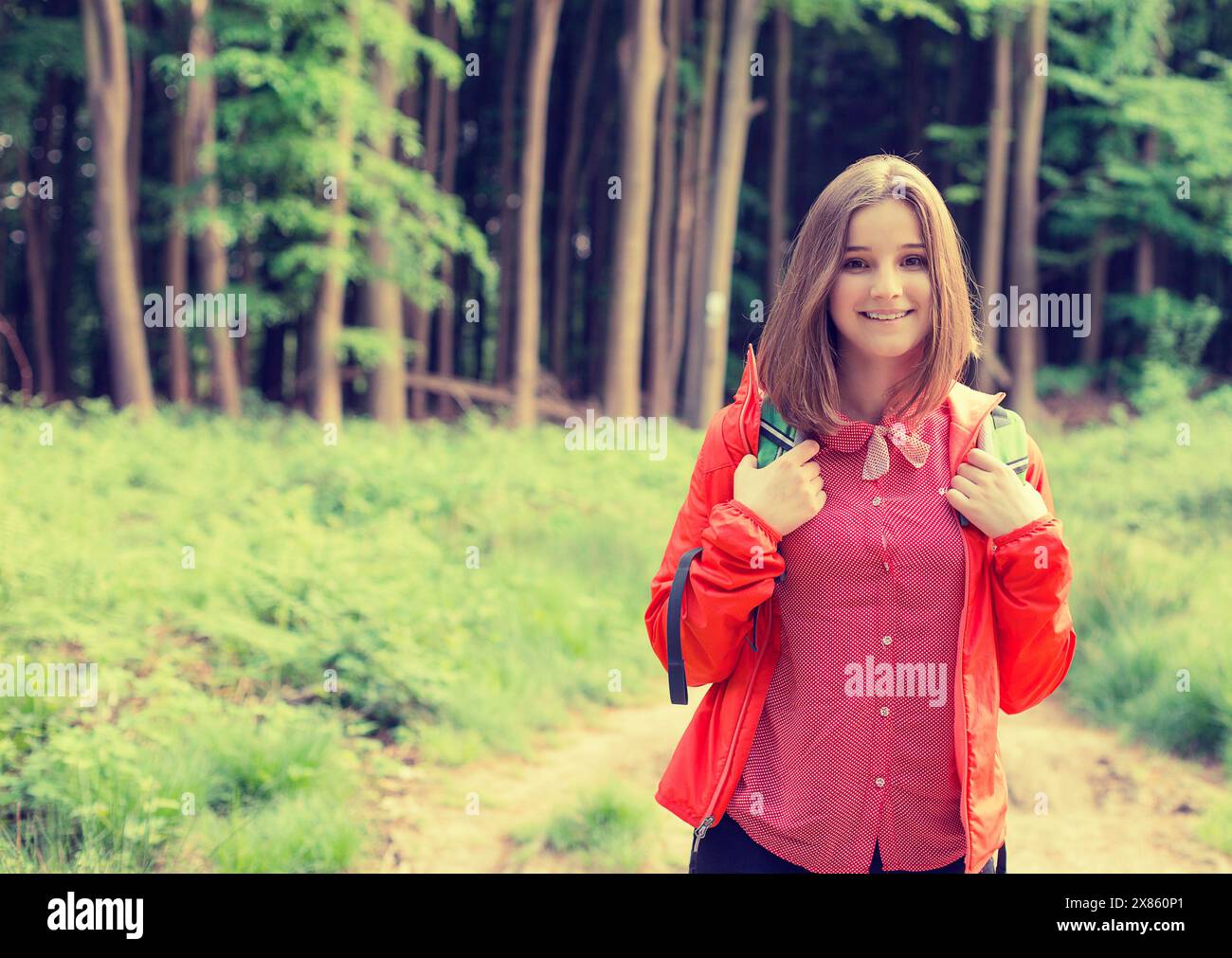 Young hiker in forest smiling enjoying nature. Positive human emotion ...