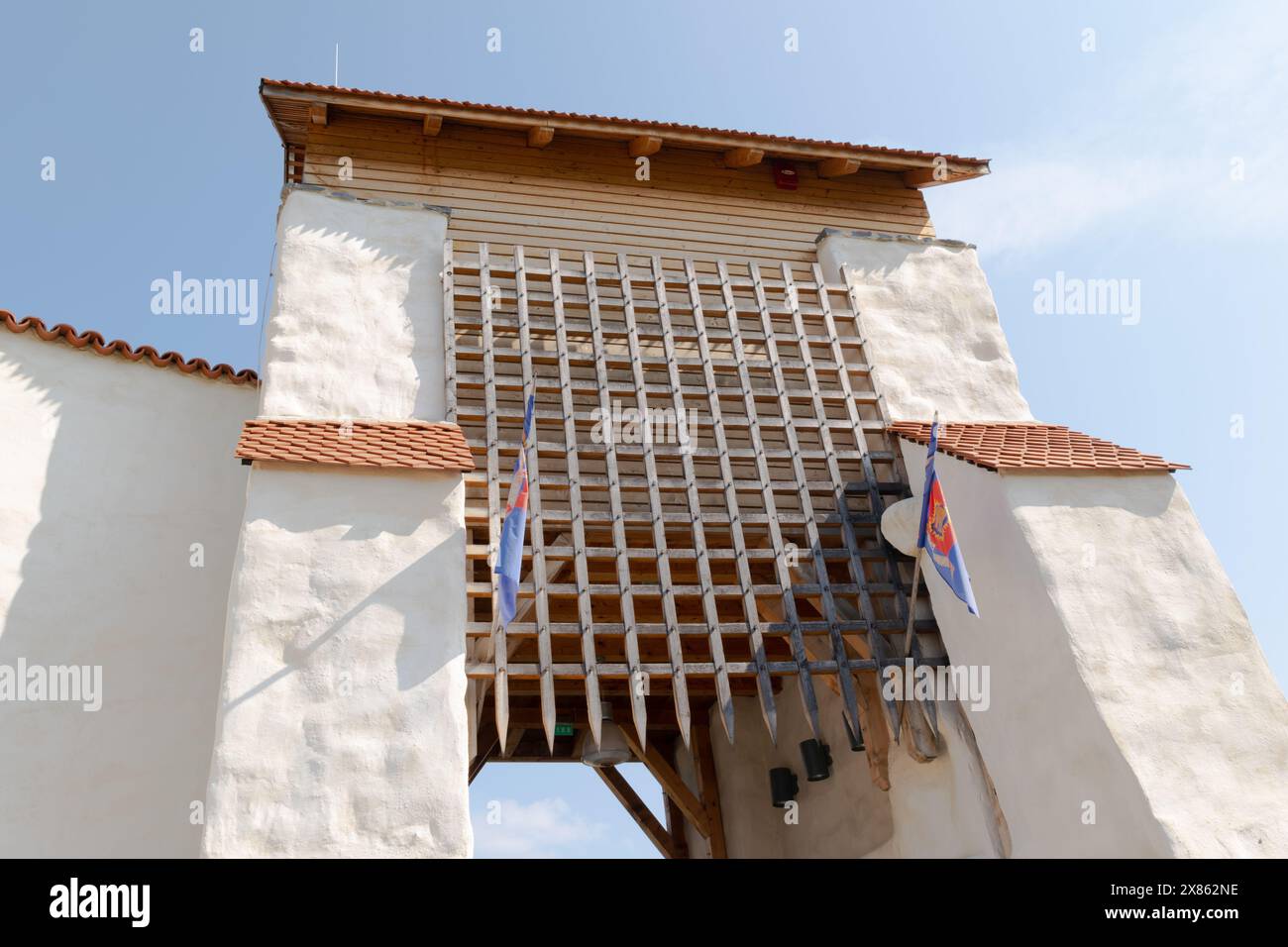Close-up of a historic medieval fortress gate with flags, showcasing ...