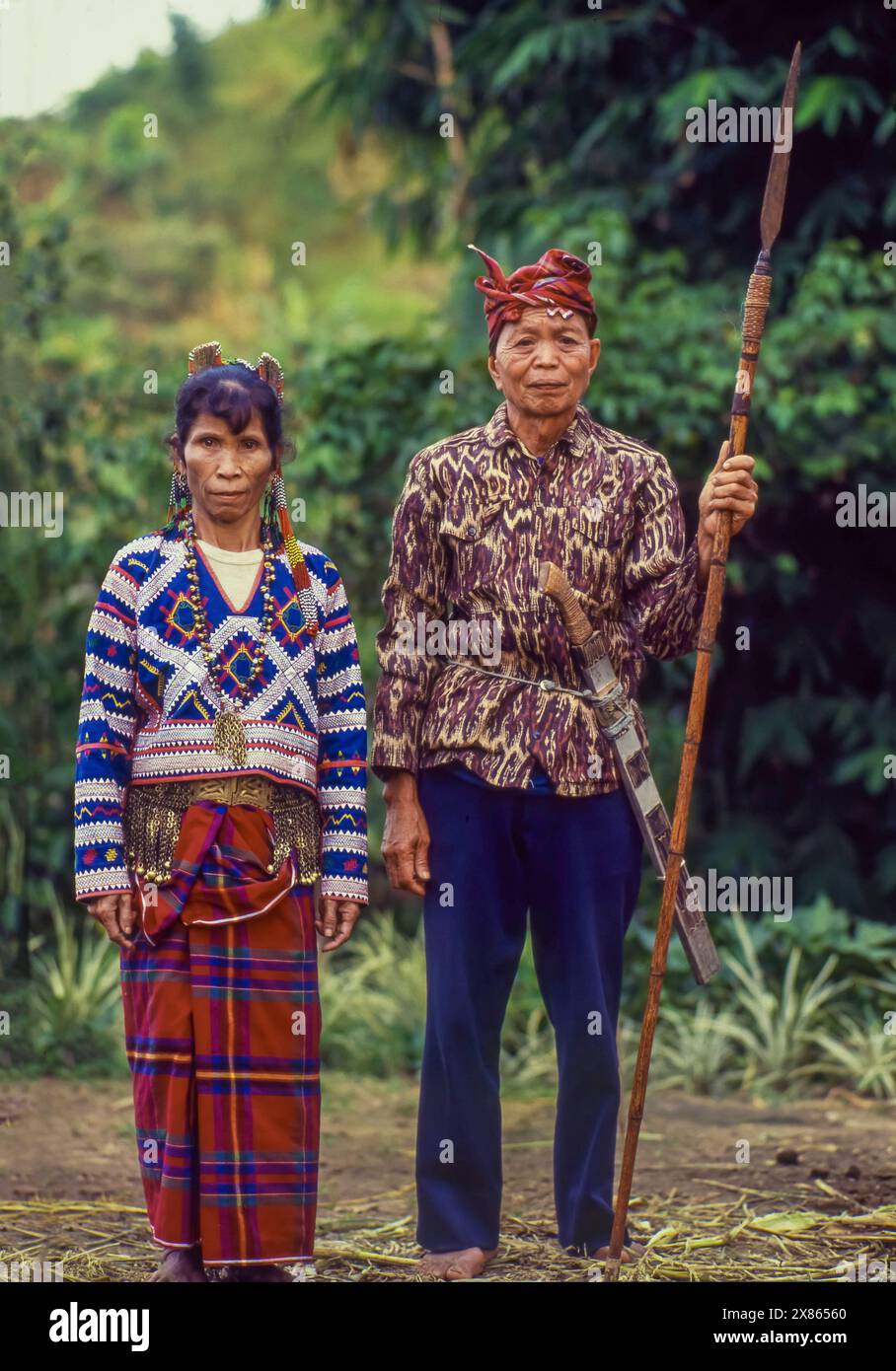 Philippines, Mindenao; Couple of the T'boli tribe, wearing traditional clothing and weapons ...