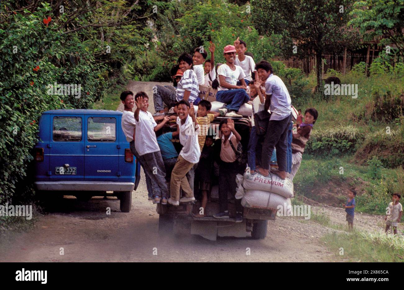 Philippines, Mindanao; Overcrowded jeepney takes visitors from a market ...
