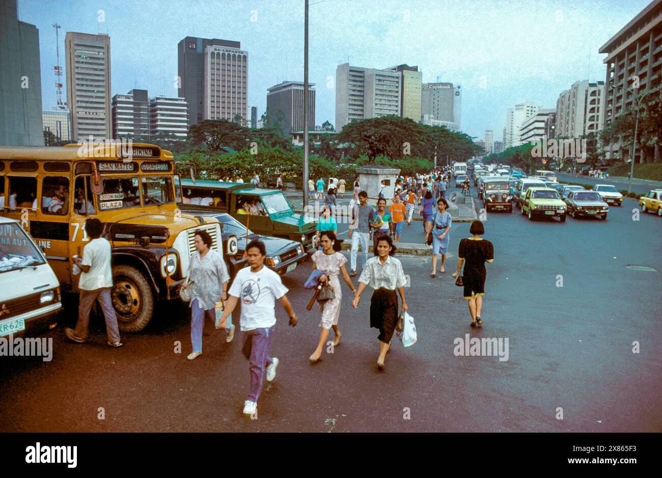 Philippines, Manila; Pedestrians cross the street in the center Stock ...