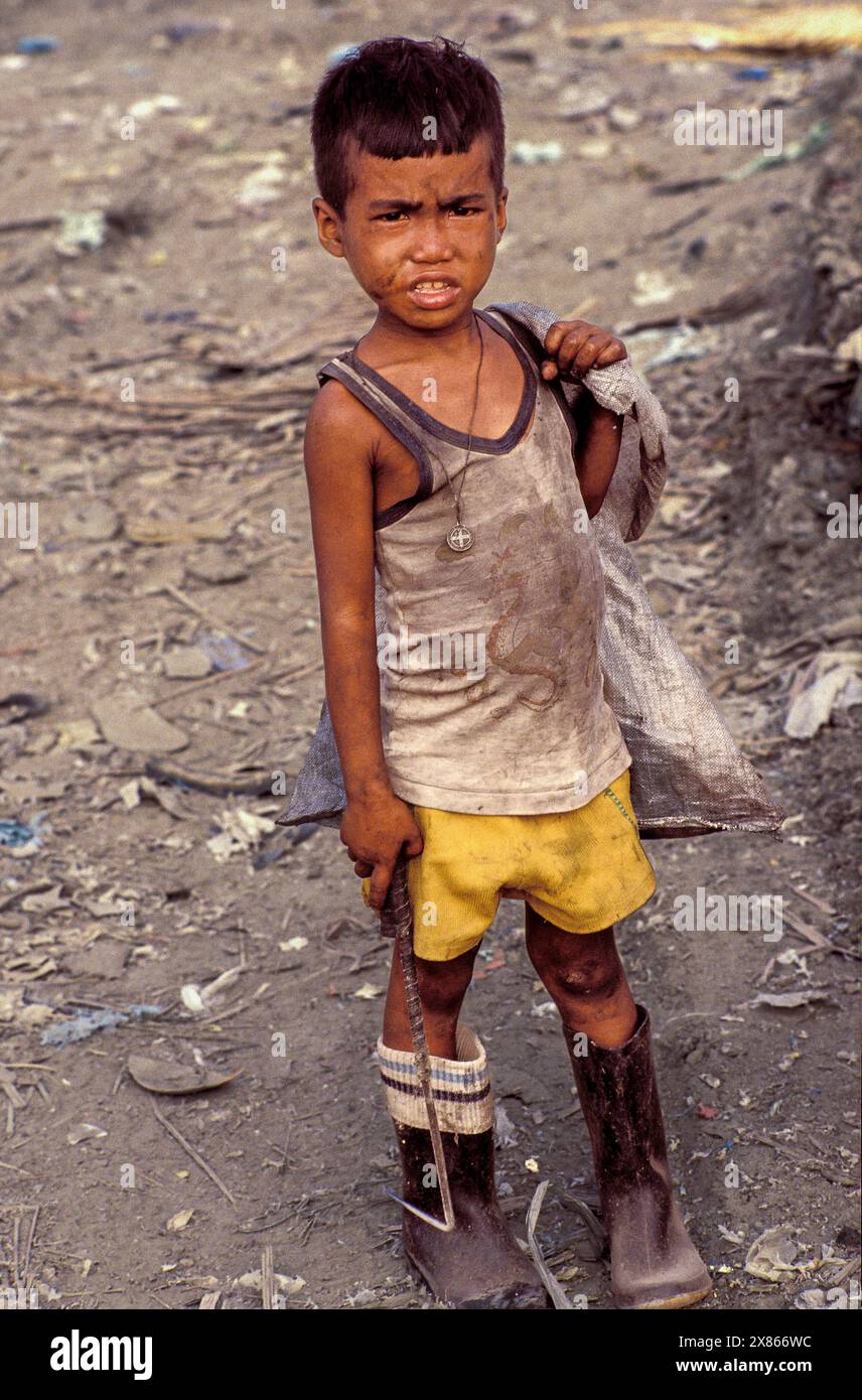 Philippines, Manila; Boy collects useful things at the garbage dump ...