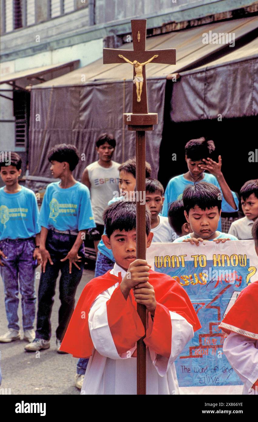 Philippines, Manila; Children walk in a catholic procession Stock Photo ...