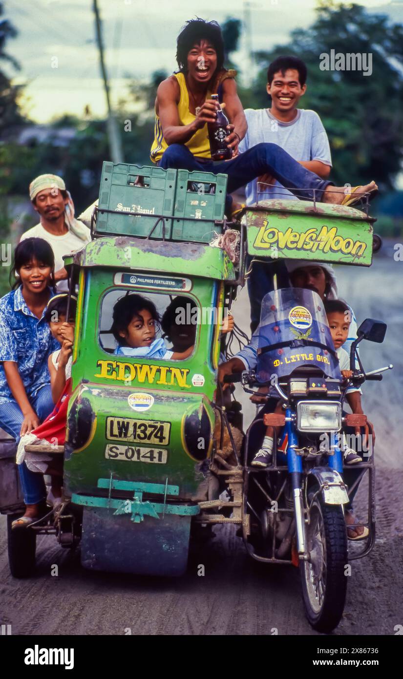 Philippines, Mindanao; motorcycle with sidecar taxis or tricycles can carry many passengers ...