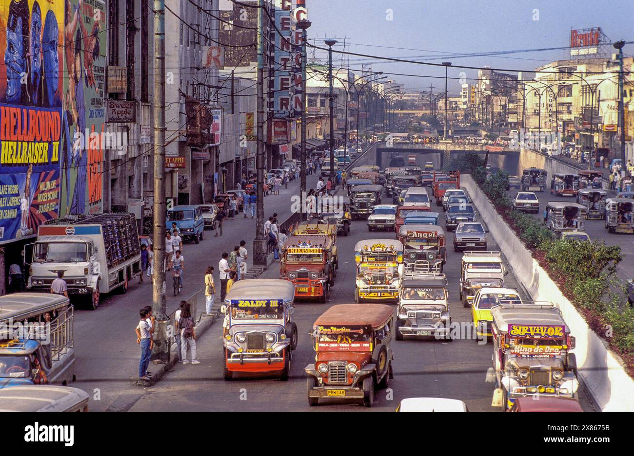 Philippines, Manila; Cars and jeepneys in a busy downtown street in ...