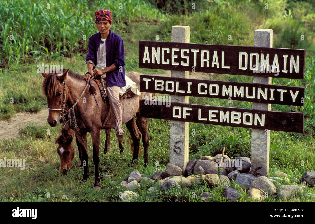 Philippines, Mindanao; Man of the T'boli tribe on a horse in front of ...