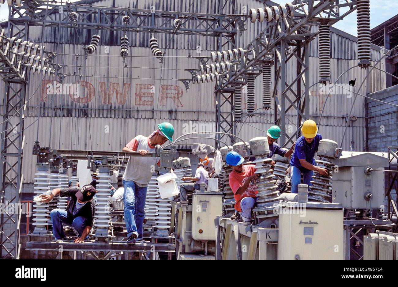 Philippines, Luzon; Labourors doing maintenance on electricity ...