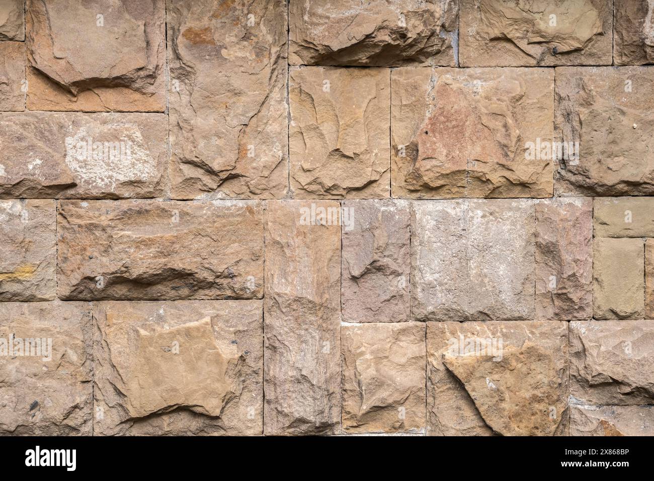 Solid house stone wall of roughly hewn stone closeup as stone ...