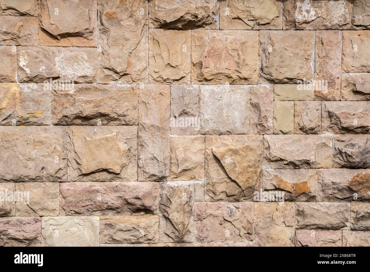 Solid house stone wall of roughly hewn stone closeup as stone ...