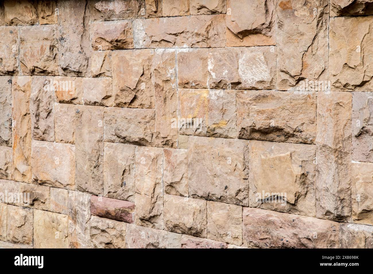 Solid house stone wall of roughly hewn stone closeup as stone ...