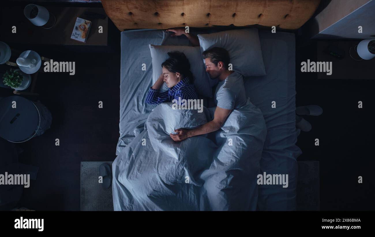 Top View Home: Happy Young Couple Cuddling Together in the Bed Sleeping ...