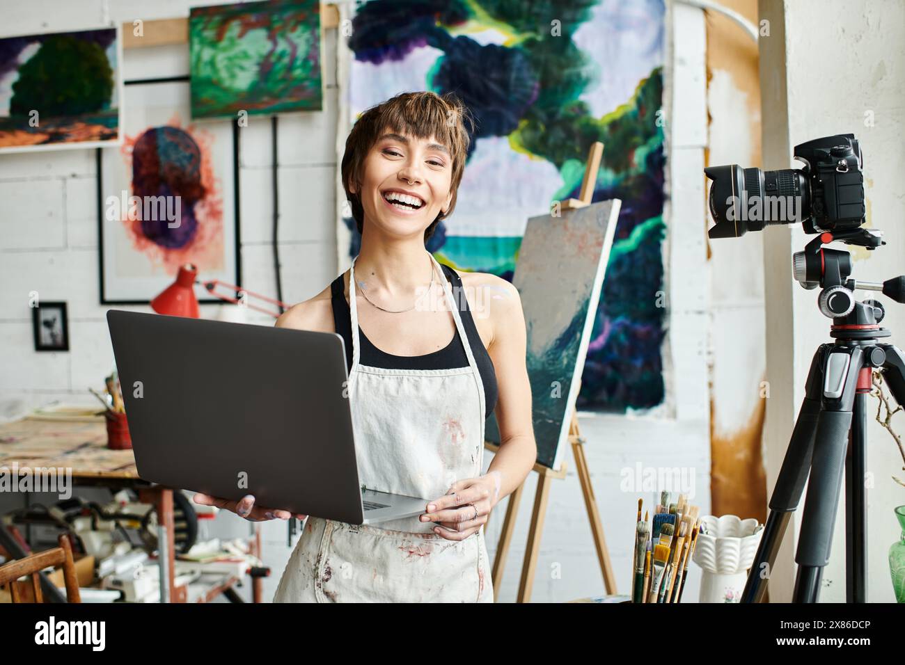 A woman confidently stands in front of a laptop computer Stock Photo ...