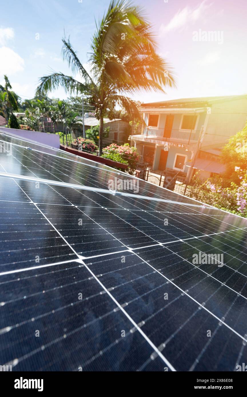 Renewable solar energy theme. Solar panel on roof in sunny tropical ...