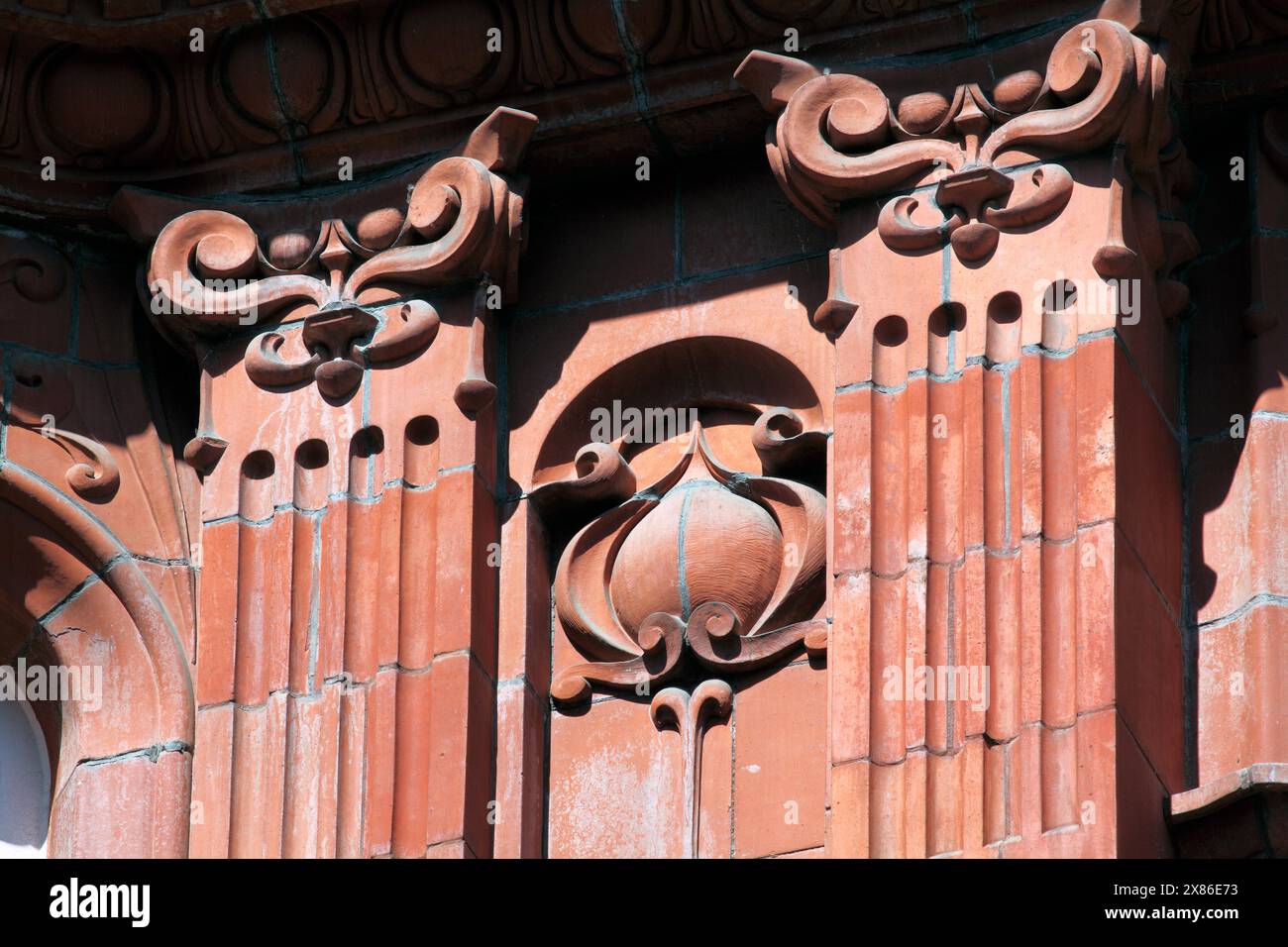Fluted pilasters and Art Nouveau details in red terracotta on council ...