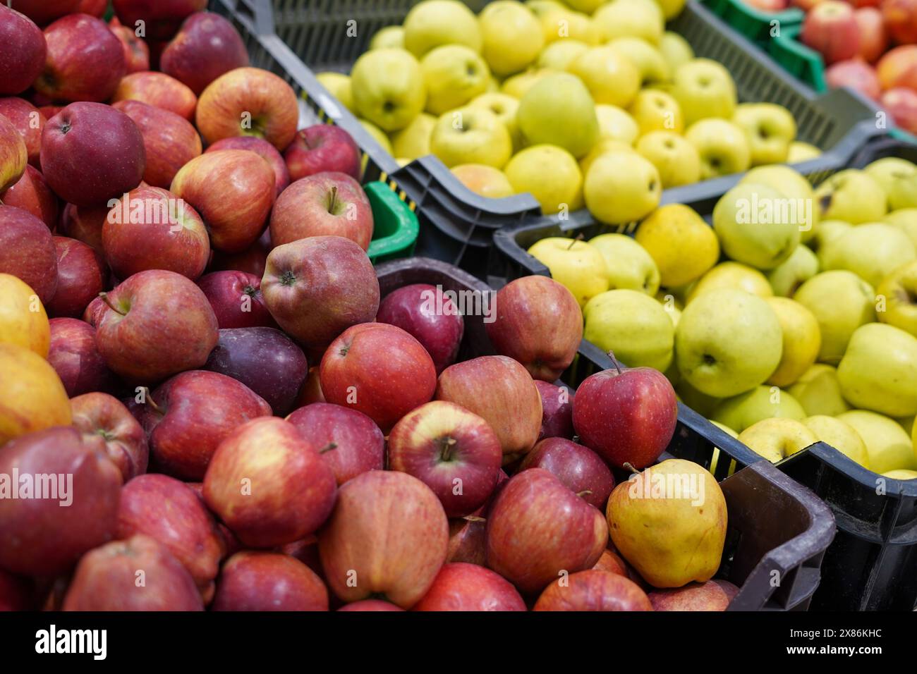 Red and yellow apples on the market counter. Apples in the cardboard ...