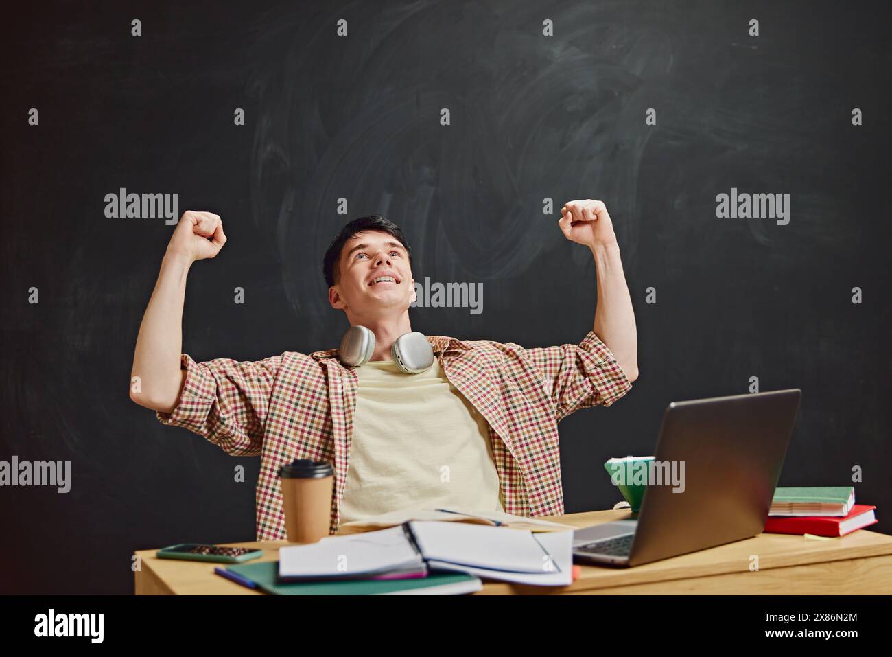 Young man, student raising hands in success and joy, getting highest ...