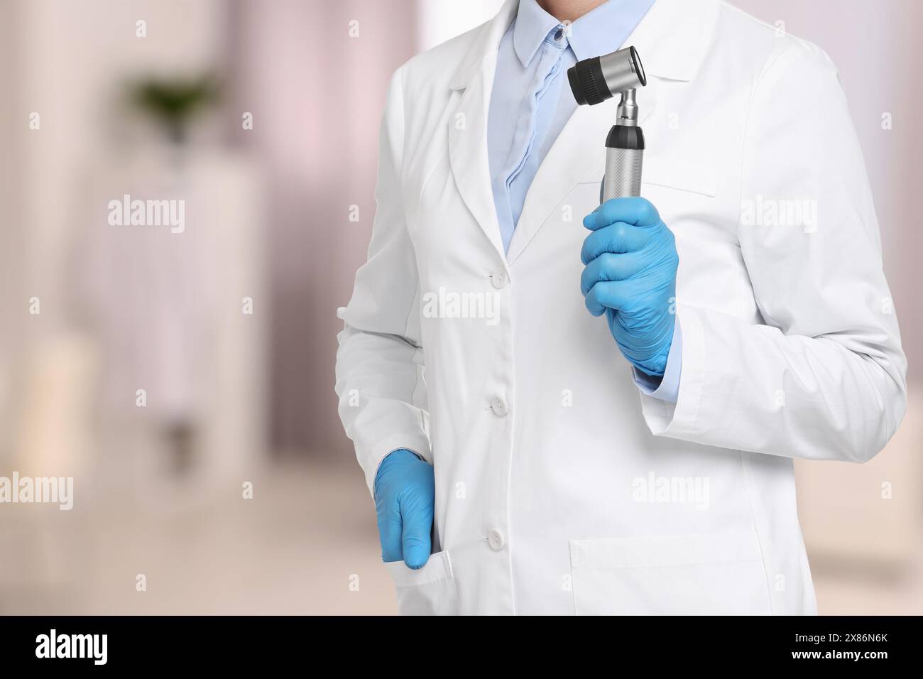 Professional dermatologist with dermatoscope on blurred background ...