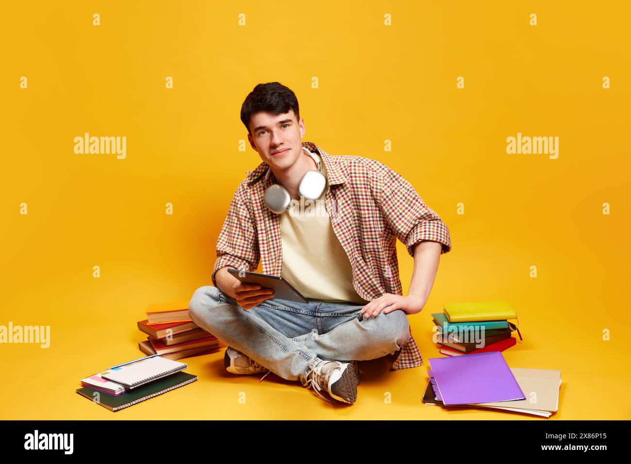Youthful Study Vibes. Young boy, student sitting on floor with table ...